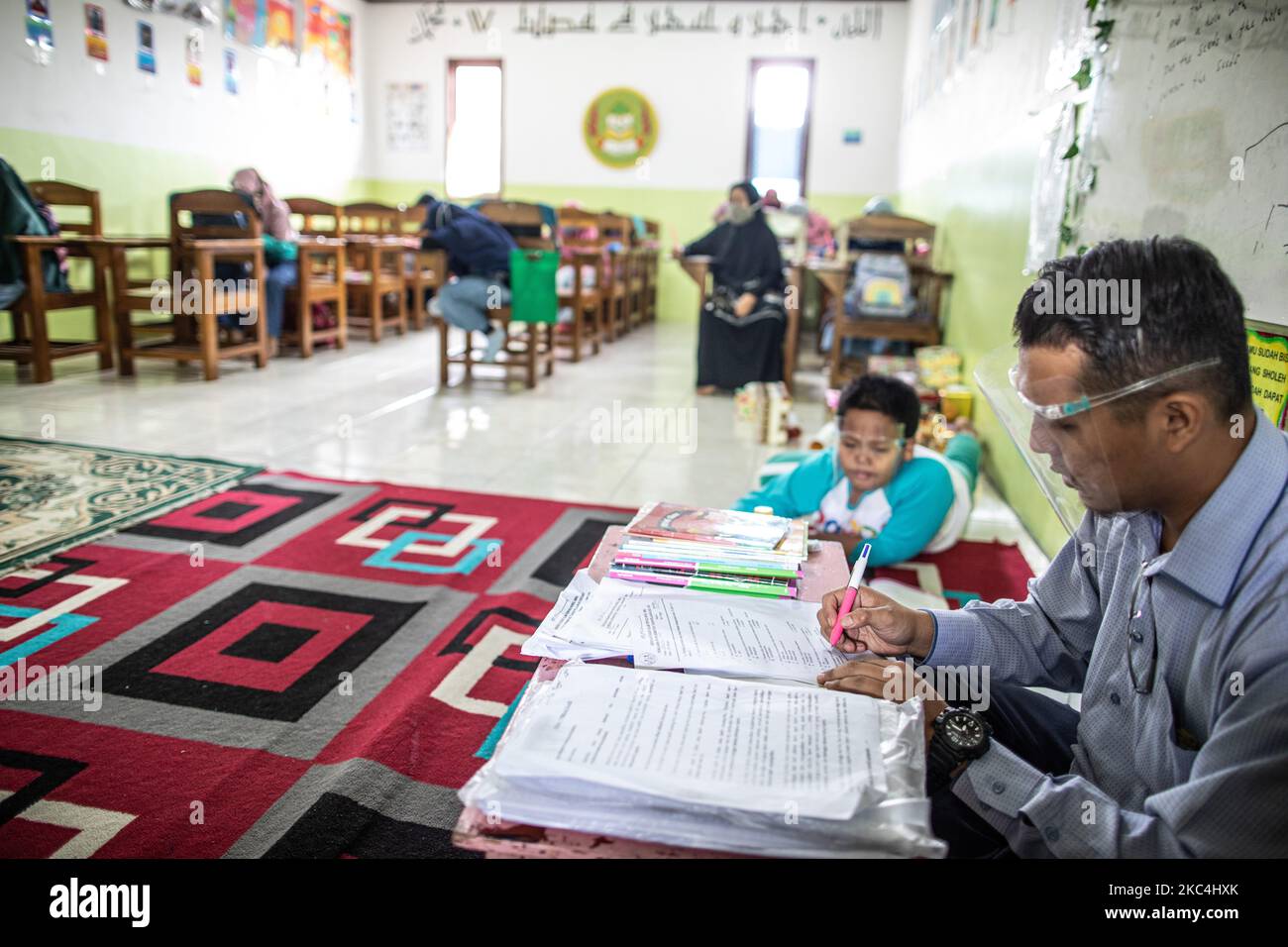 Teacher checing paper examination. An Islamic School in South Tangerang ...