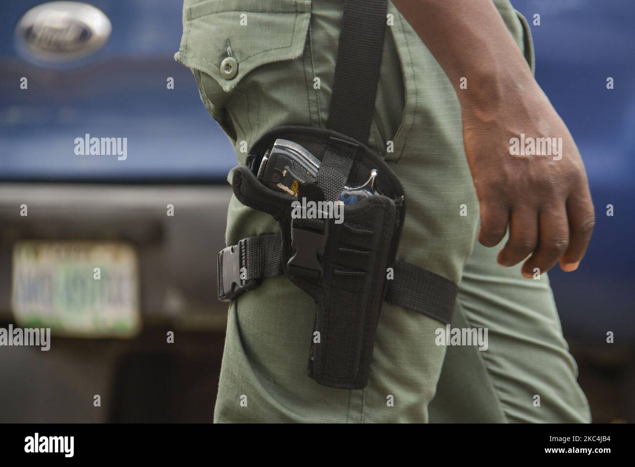 A police officer on duty with Glock service revolver patrols during ...