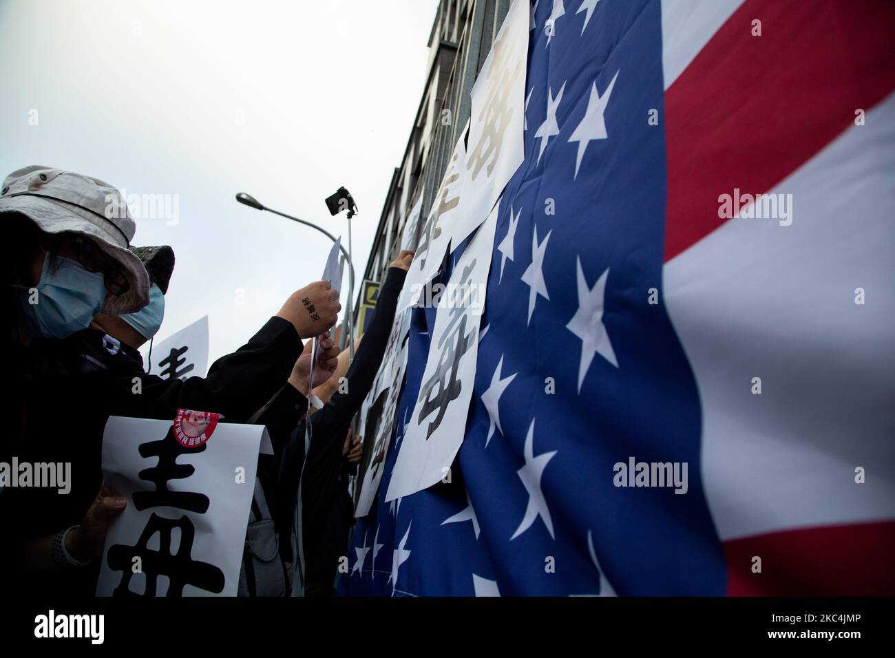 People stick the signs that read "Poison" on American's National flag ...