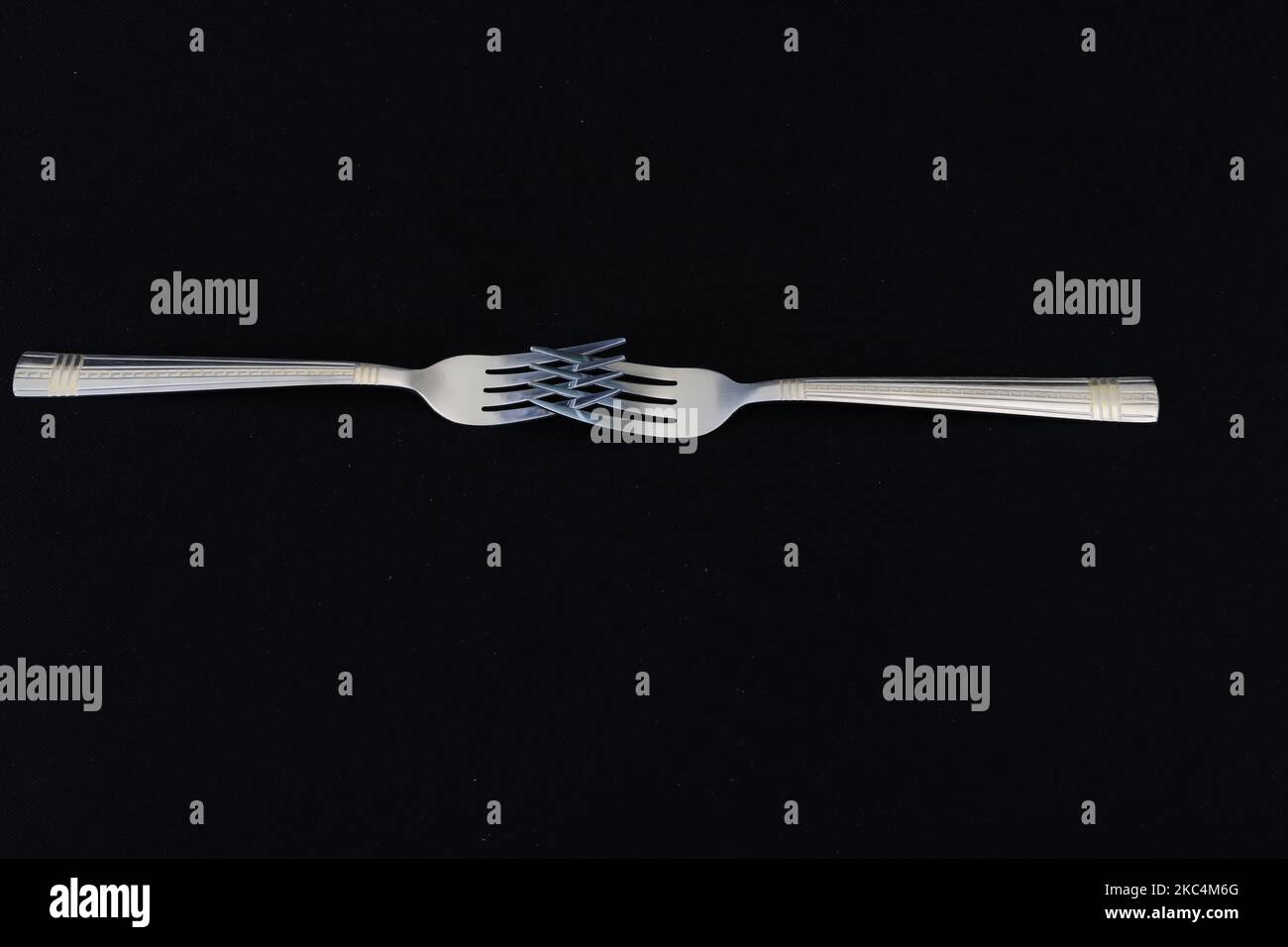 The two forks isolated on black background Stock Photo - Alamy