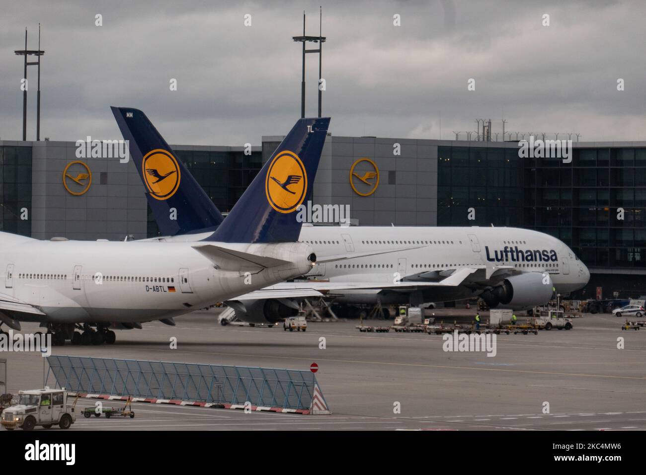 An Airbus A380 and Boeing 747 Jumbo jet tail lineup, row of Lufthansa ...