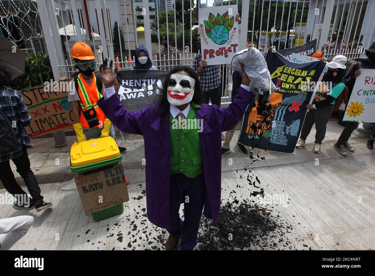 Environmental activists take a theatrical action during a demonstration ...