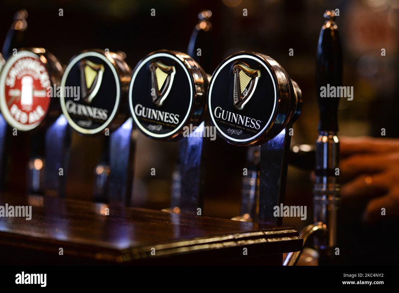 A bartender pulls a pint of Guinness inside a pub in Dublin's city ...