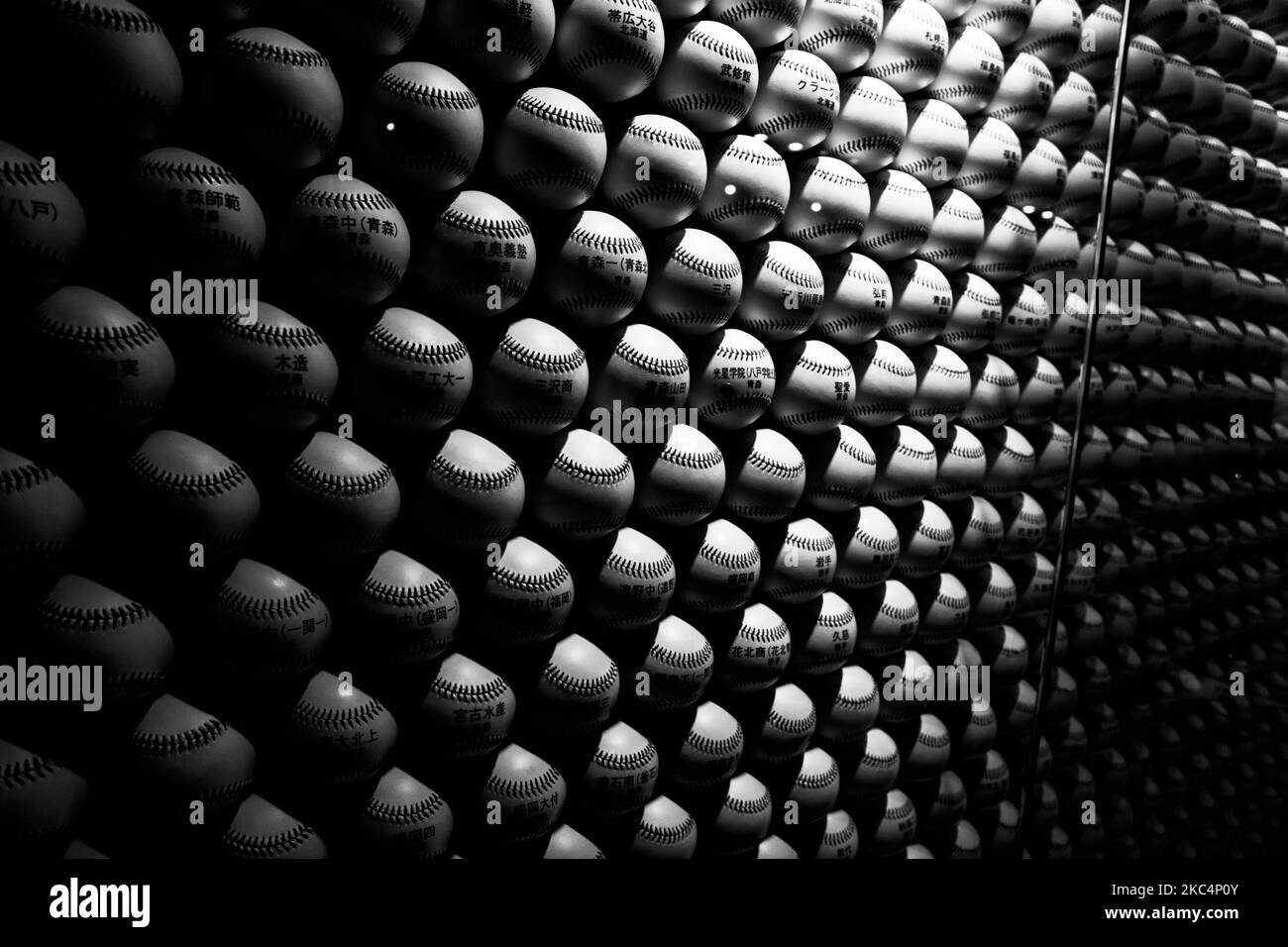 A grayscale shot of a wall of baseballs in the Museum of Hanshin ...