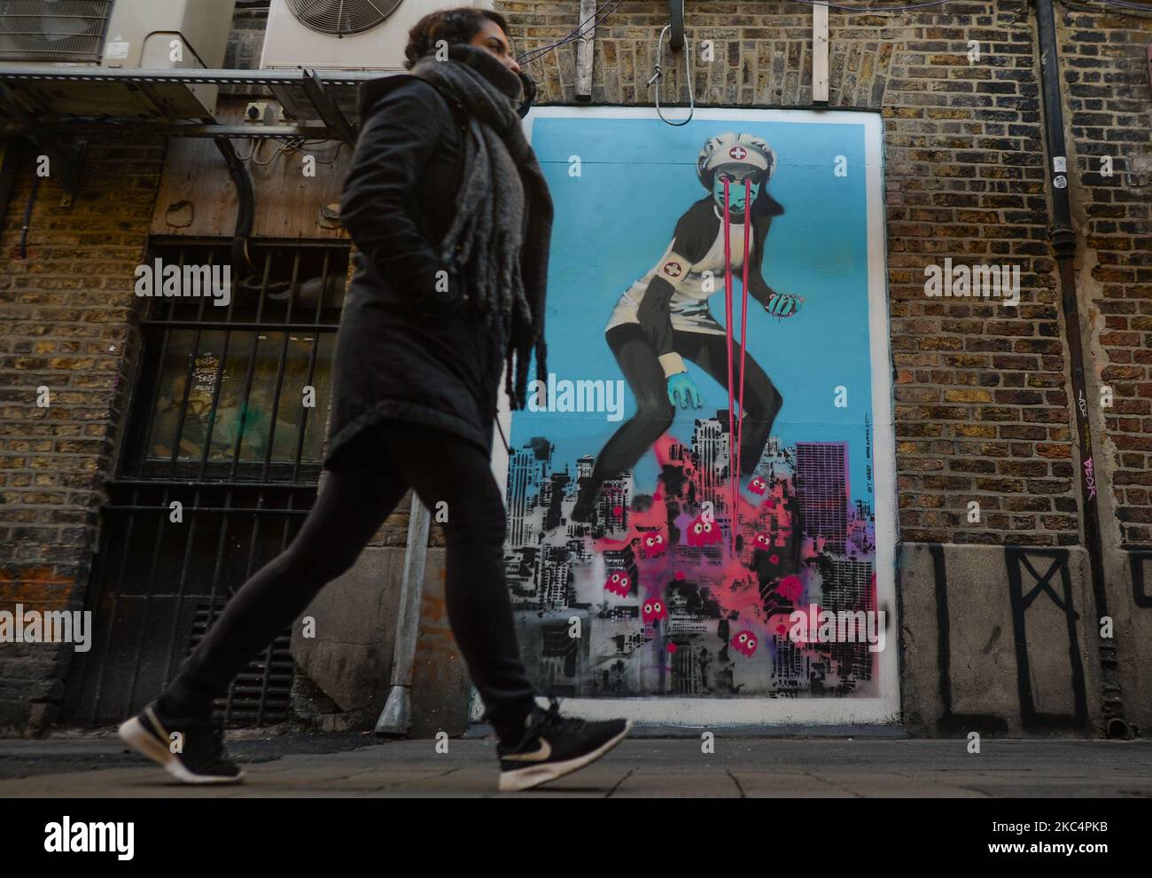 A woman walks by the mural '50 FT HEROES' by the Irish artist Shane ...