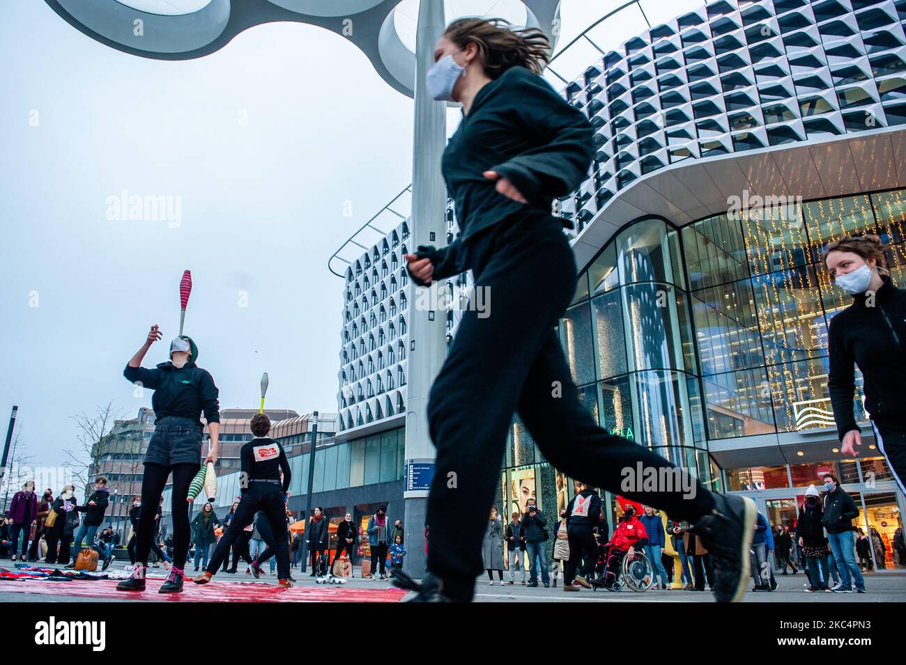 Climate acrobats are performing in front of the biggest shopping mall ...