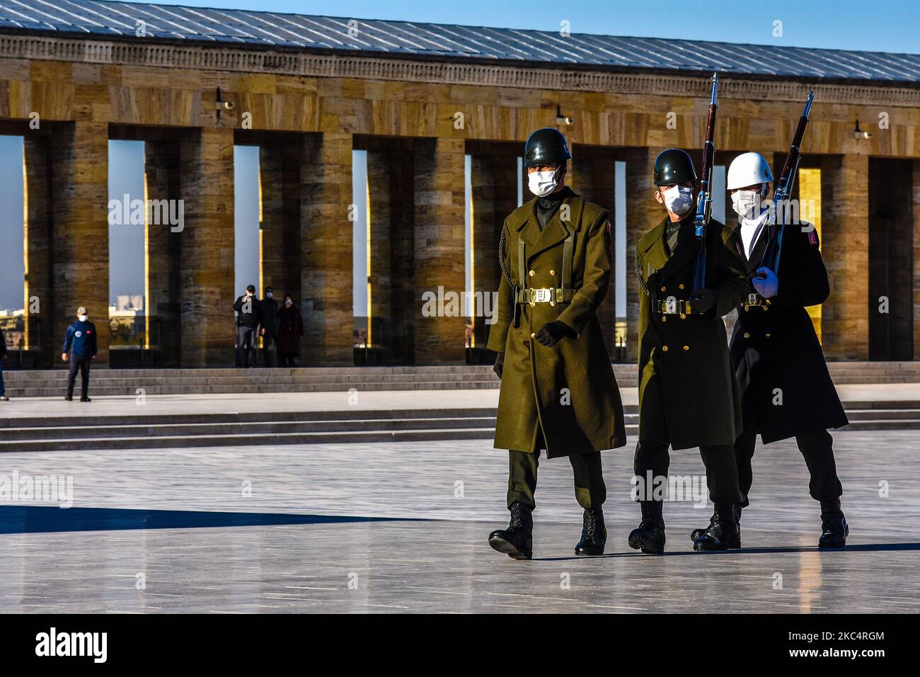 Turkish soldiers wearing protective face masks march during a change of ...