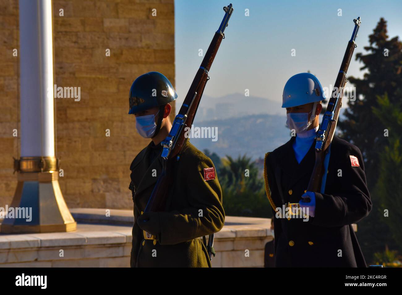 Turkish soldiers wearing protective face masks march during a change of ...