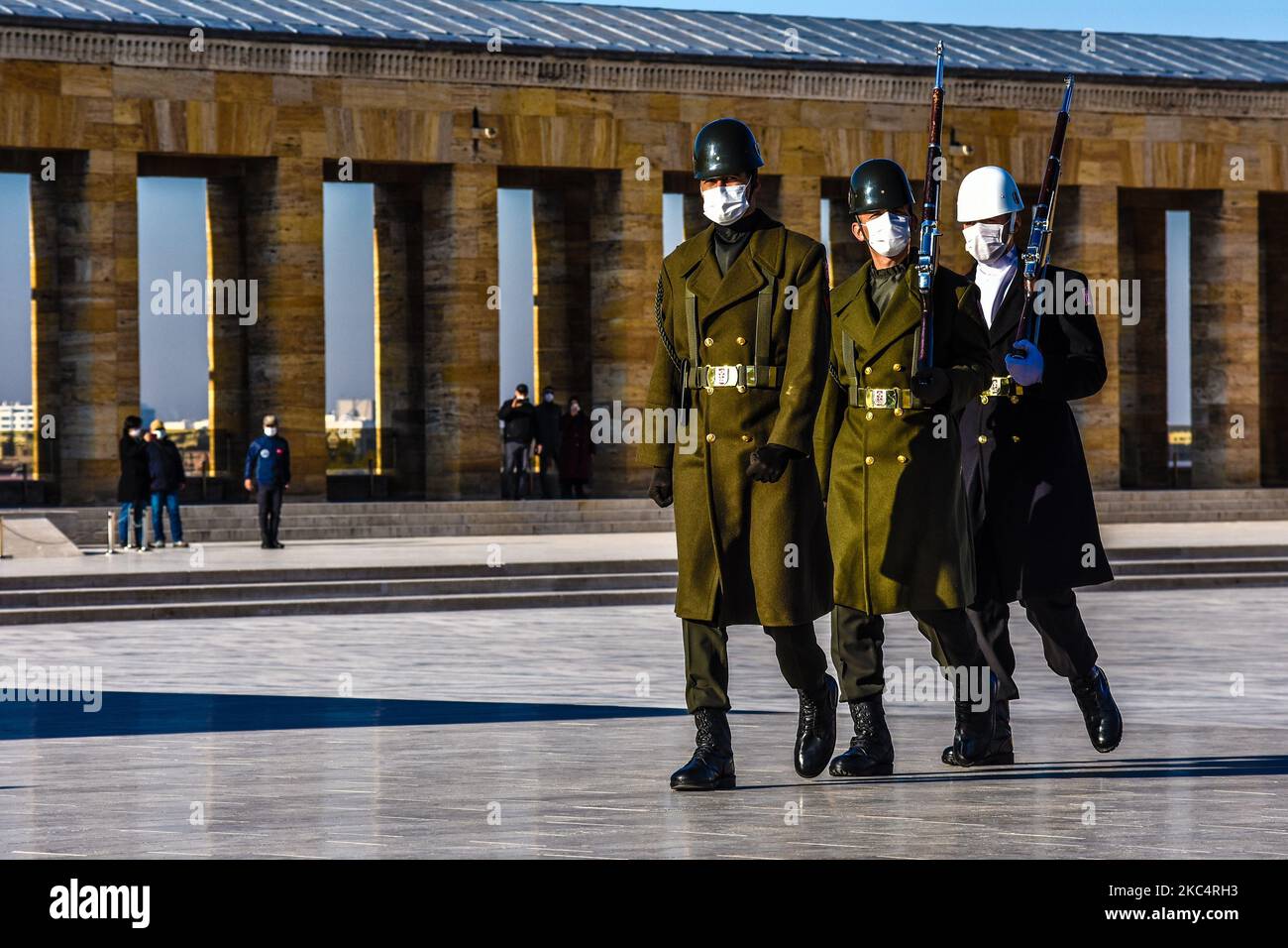 Turkish soldiers wearing protective face masks march during a change of ...
