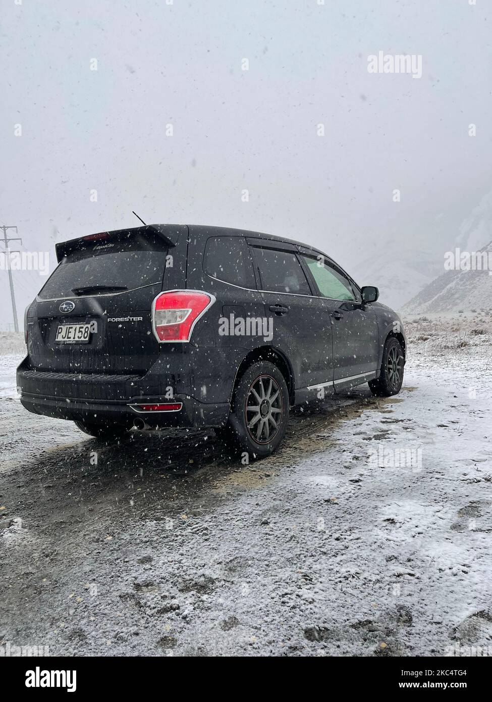 A 2013 Subaru Forester rear view in foggy Arthur's pass covered in snow ...