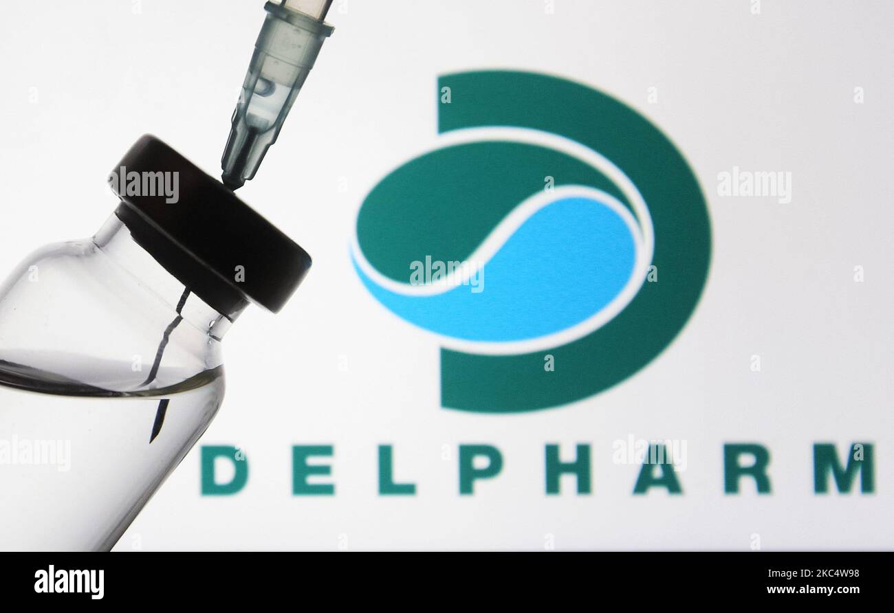 A medical syringe and a vial in front of the Delpharm logo are seen in ...