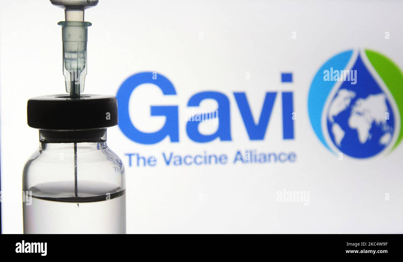 A medical syringe and a vial in front of the GAVI the Vaccine Alliance ...