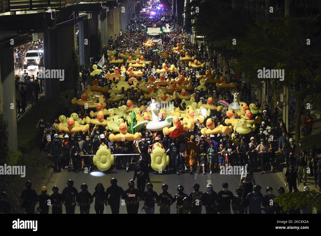 Thai anti-government protesters march with inflatable rubber ducks ...