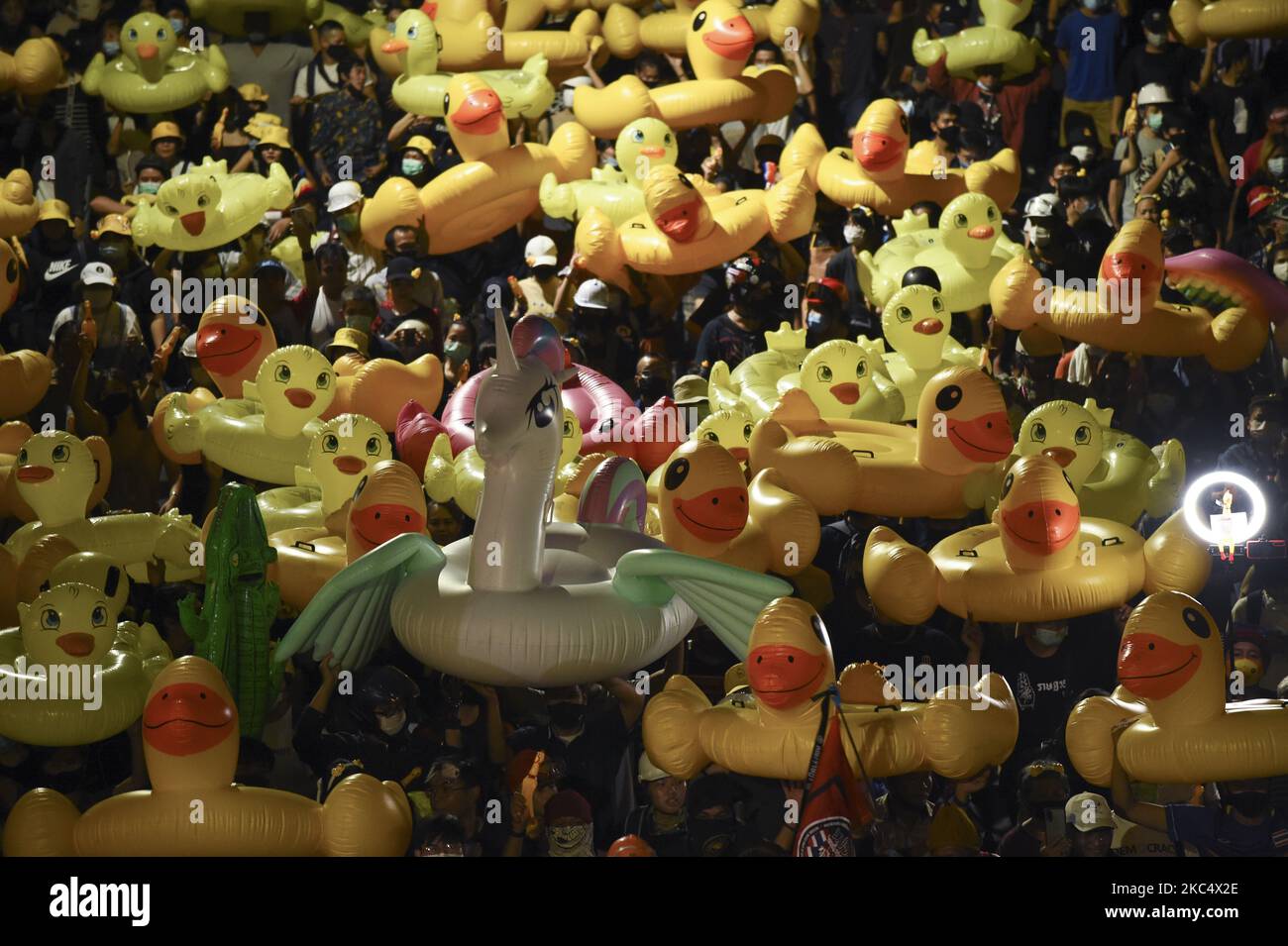 Thai anti-government protesters march with inflatable rubber ducks ...