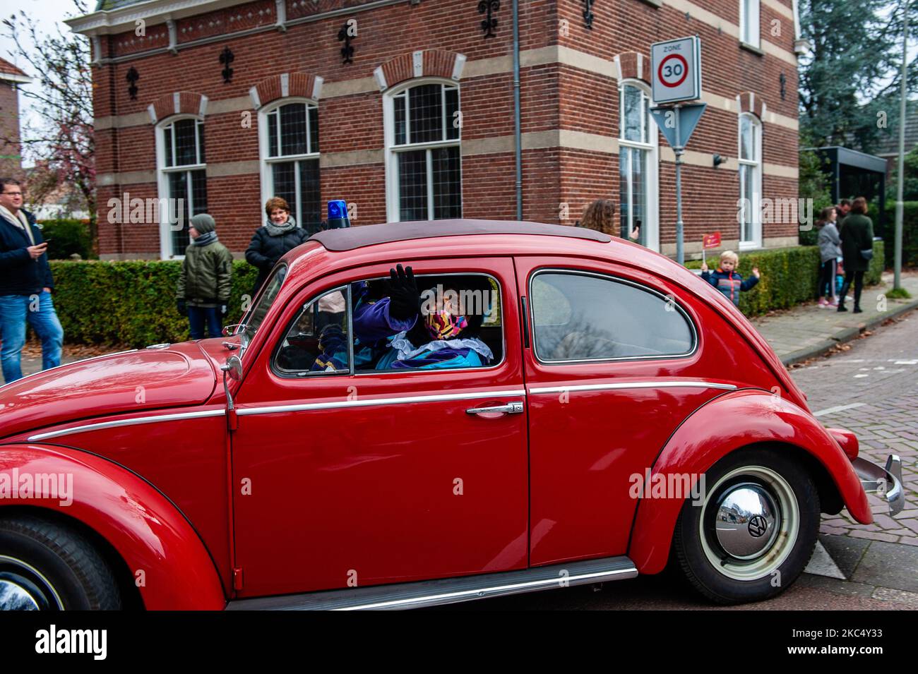 Some of the Petes (Sinterklaas’ helpers) are inside of a car, greeting ...