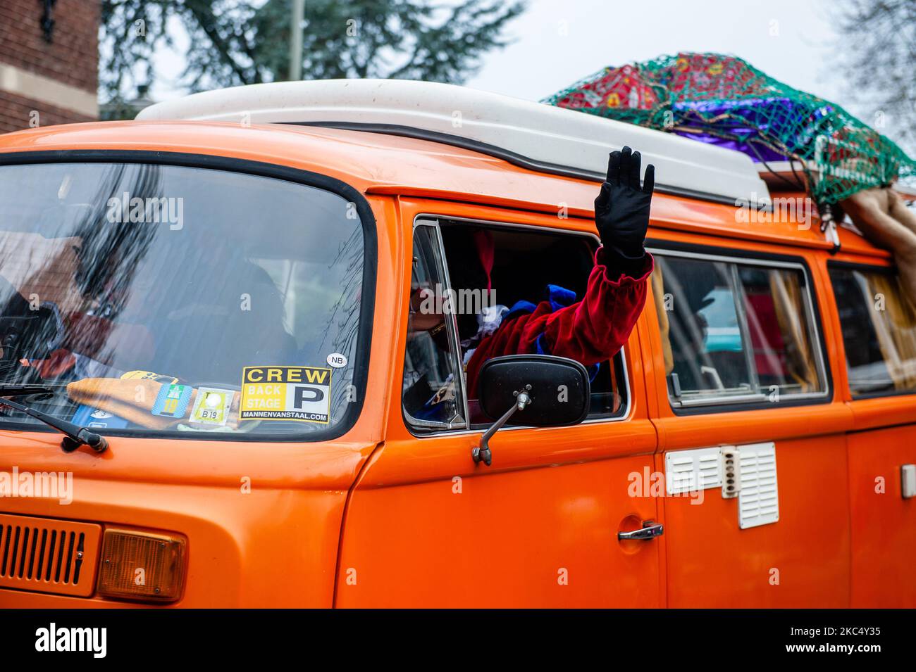 Some of the Petes (Sinterklaas’ helpers) are inside of a car, greeting ...