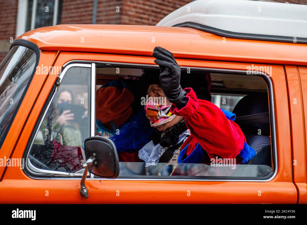 Some of the Petes (Sinterklaas’ helpers) are inside of a car, greeting ...