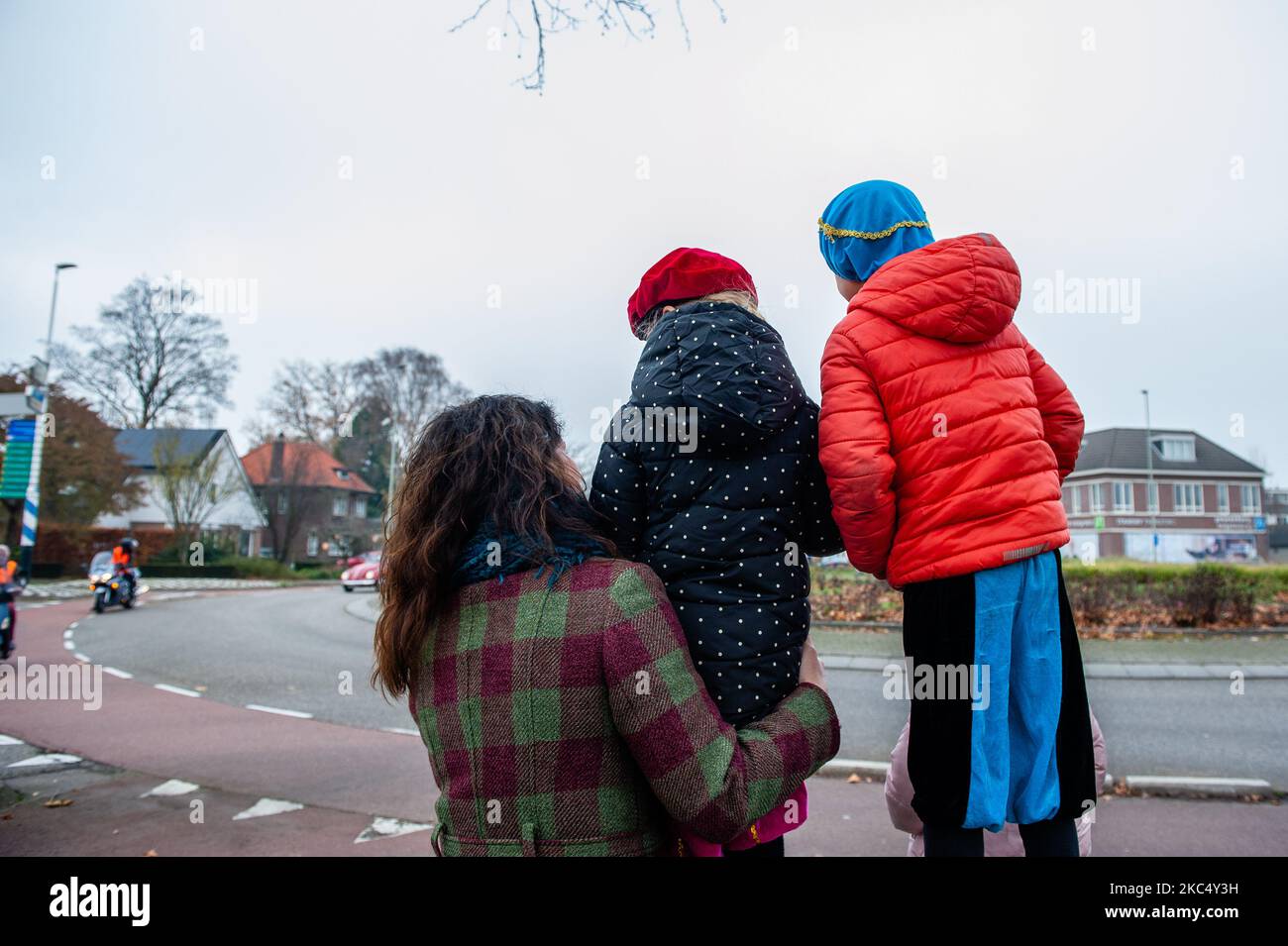 A couple of children are waiting the arrival of St. Nicholas on a bus ...