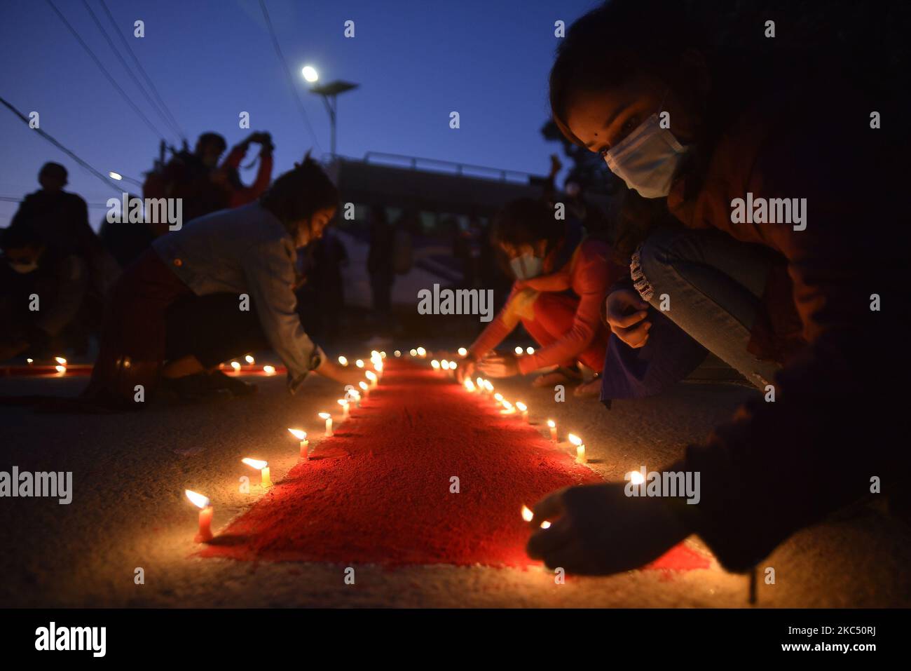 Nepalese people lit candles around the symbol of RED AIDS during Eve of ...