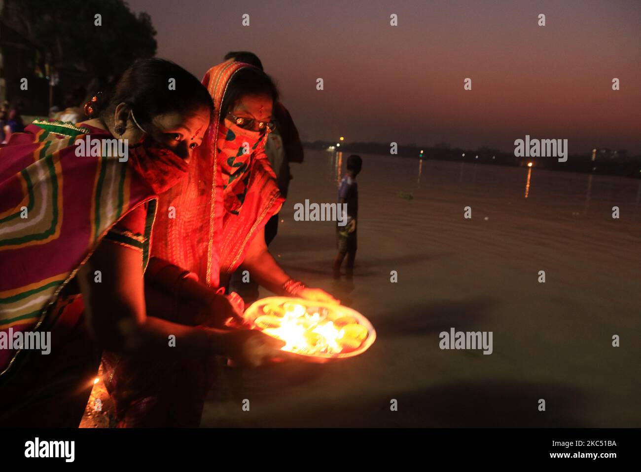 Hindu devotees light lamps during the ''Dev Deepawali'' Festival, in ...