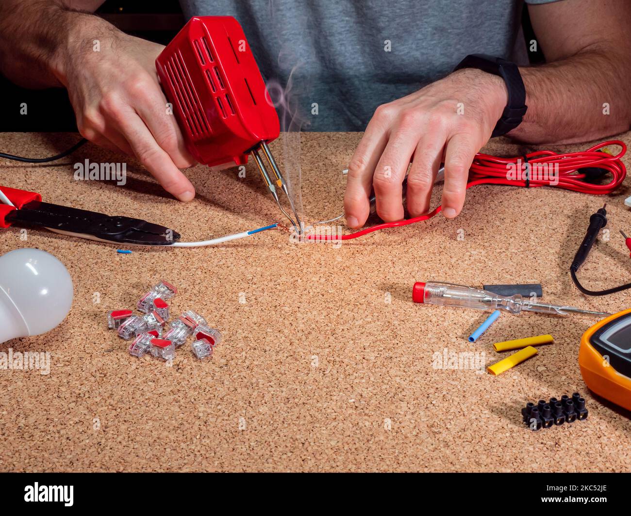 soldering - connecting wires with tin and soldering iron, workshop, in ...