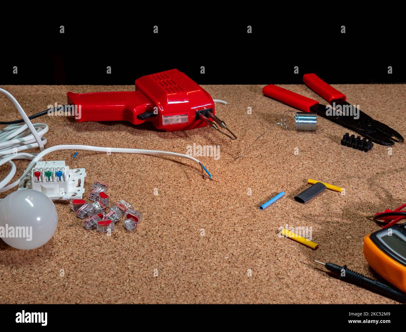 soldering - connecting wires with tin and soldering iron, workshop, in the background electrical ...