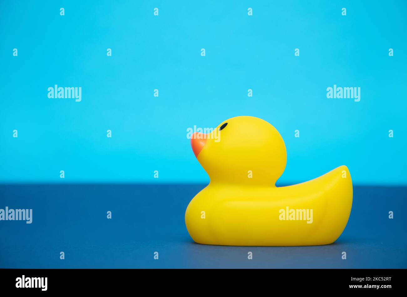 A 3D rendered illustration of a yellow rubber duck on a dark blue ...