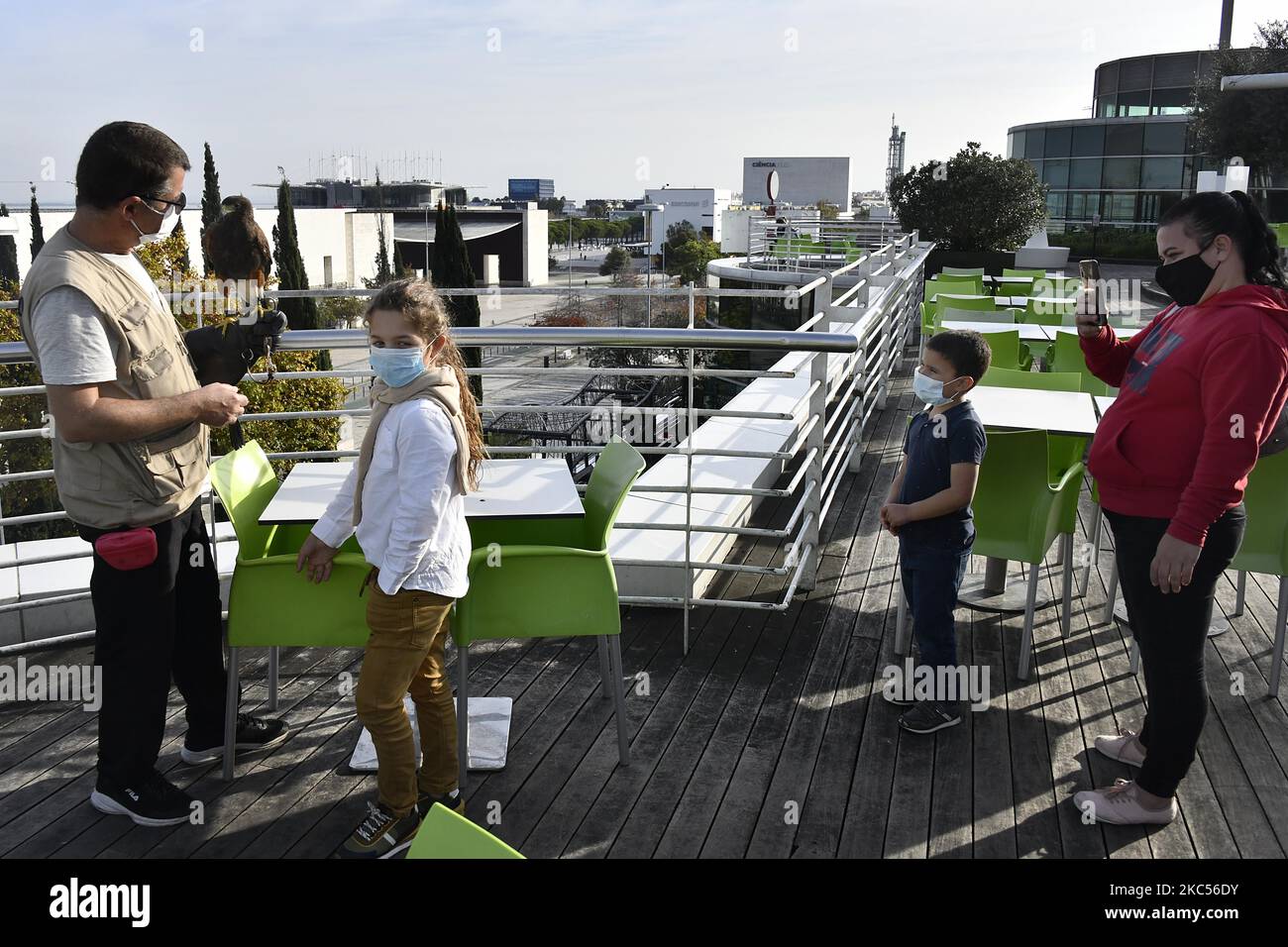 A master falconer demonstrates to visitors the benefits of a bird of ...