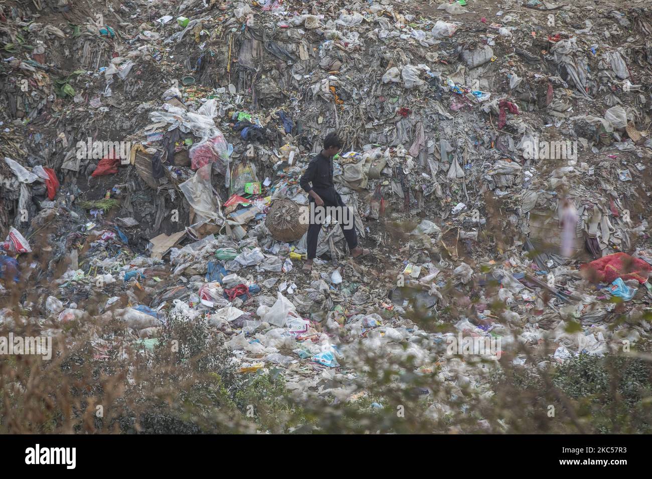 A man seen walking through smokes coming out from garbage burn in Dhaka ...