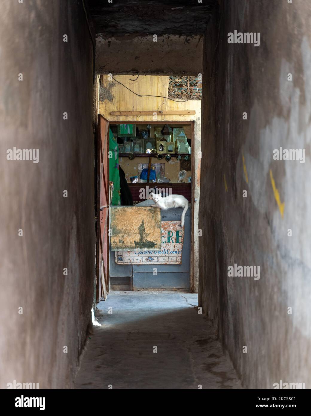 A vertical shot of a narrow path between buildings with the background ...