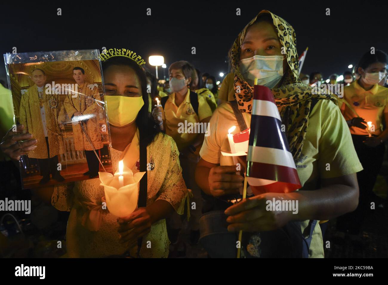 Thai well-wishers attend a ceremony hold a candles in remembrance of ...