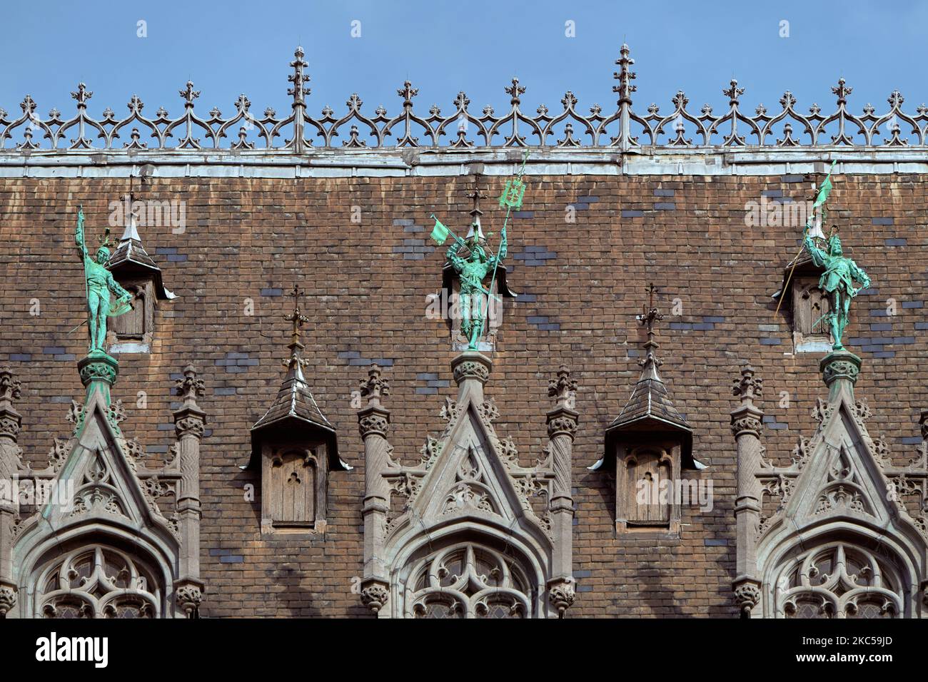A close-up shot of the bronze statues crowning the King's house ...