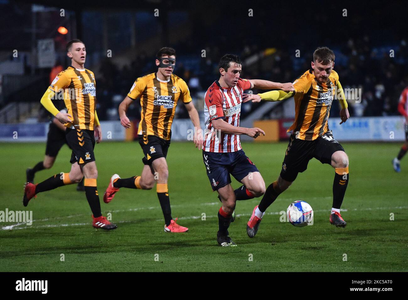 Oldham Athletic's Ben Garrity tussles with Cambridge United's Robbie ...