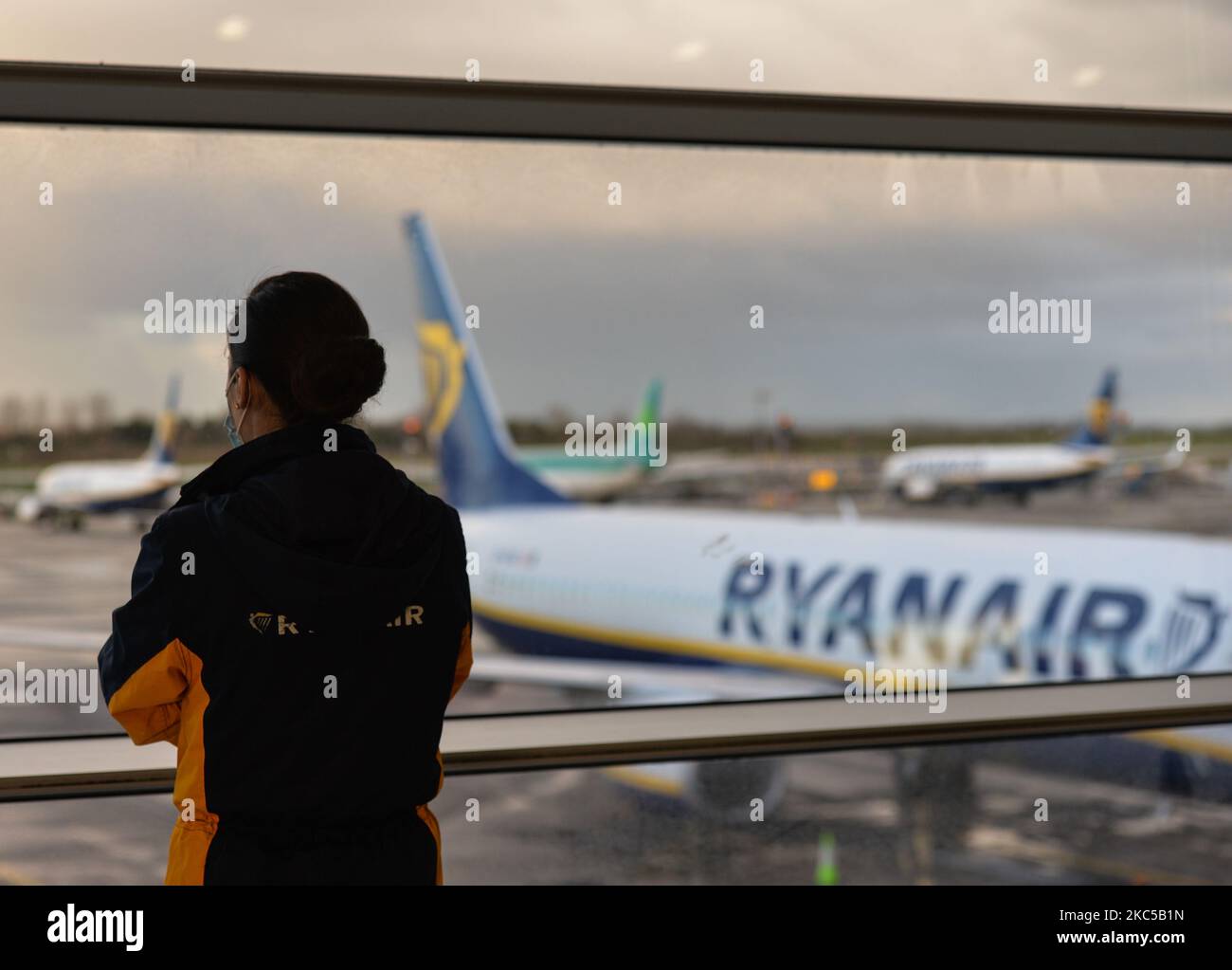 A member of Ryanair cabin crew looks out of the window at Ryanair ...