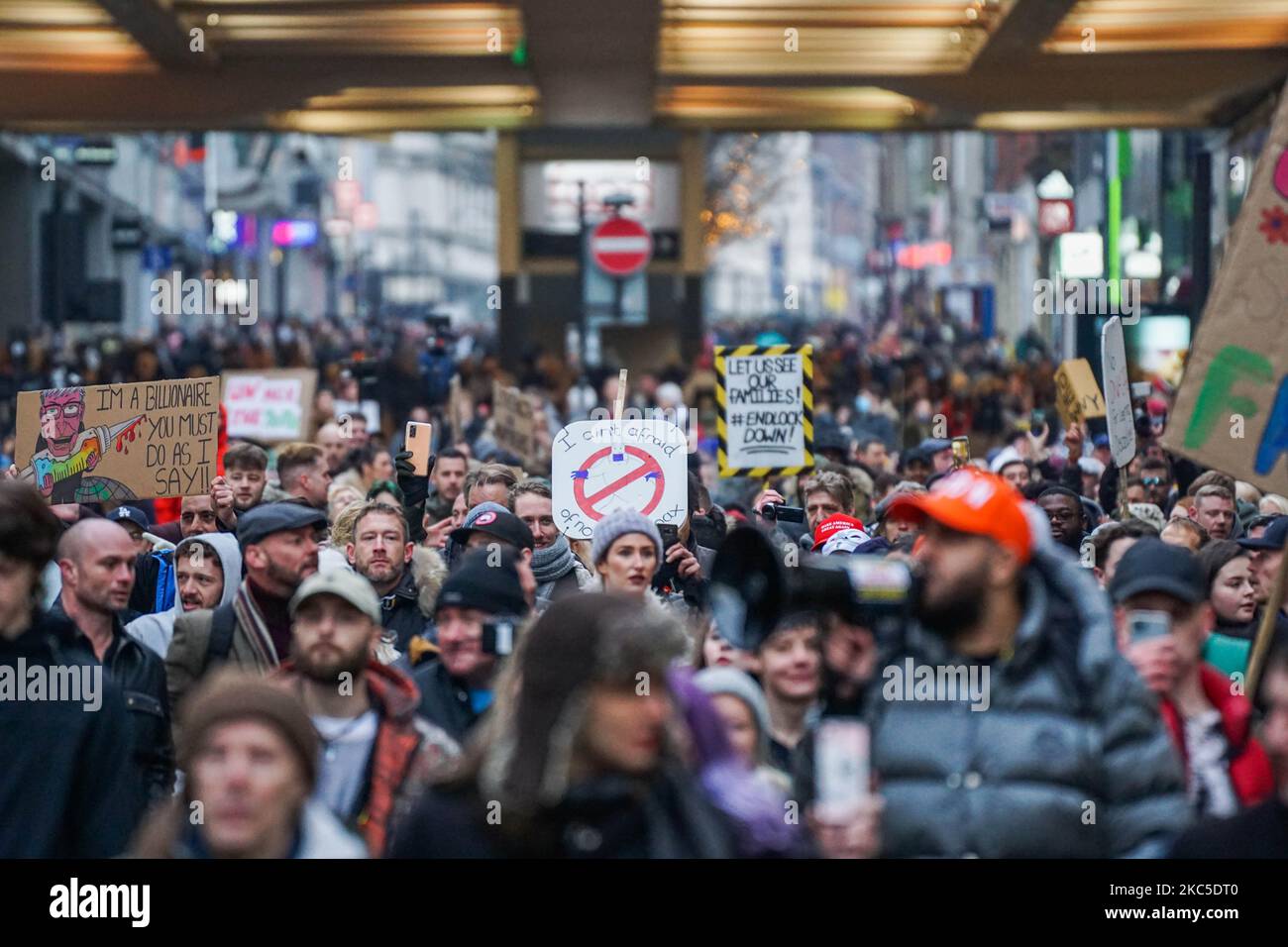 Protesters hold placards and shout slogans during an anti-lockdown ...