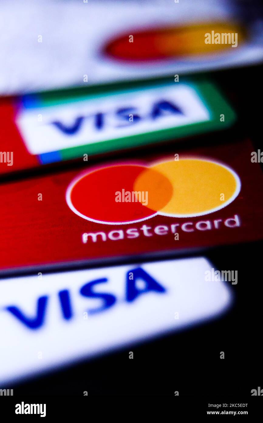 Mastercard and Visa logos are seen on credit cards in this illustration ...
