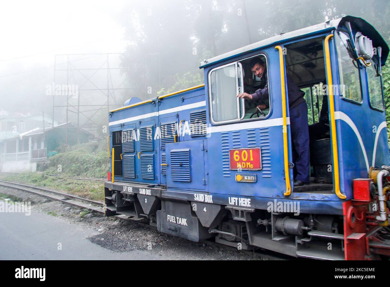 The train operator salutes with a hand gestrue. The Darjeeling ...