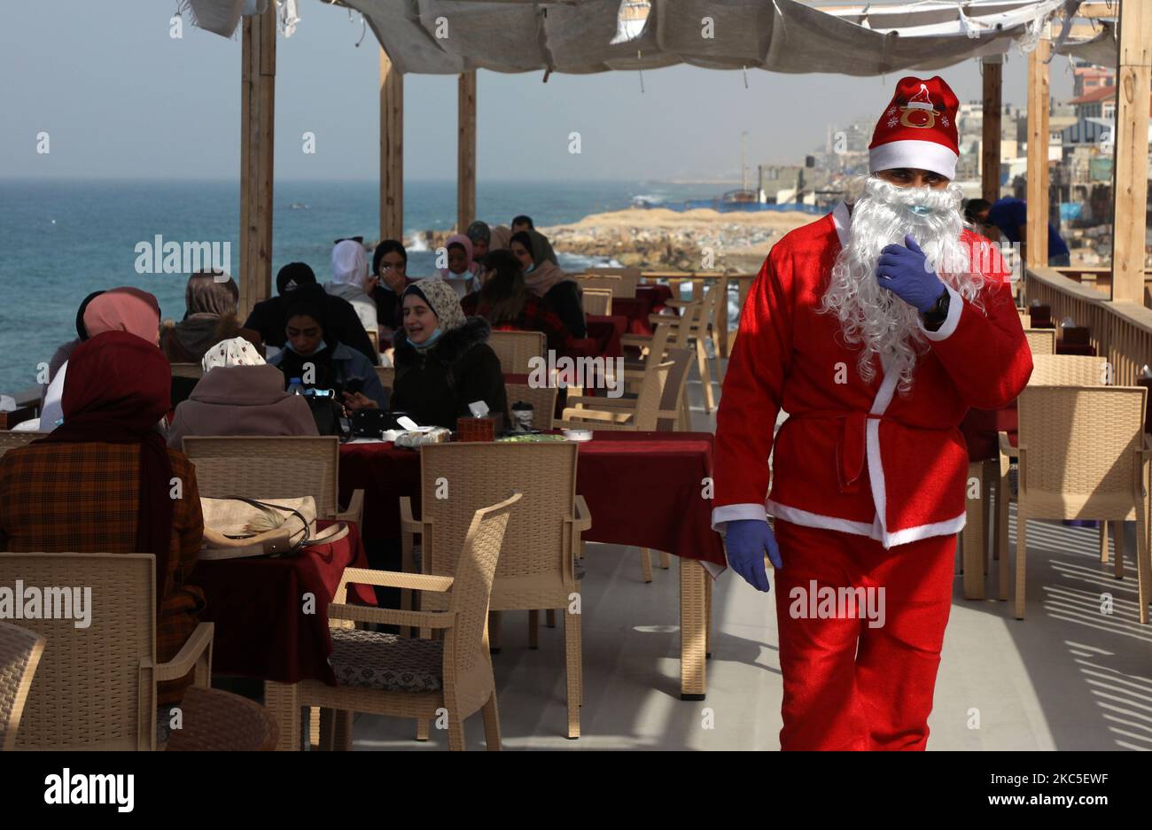 A Palestinian worker dressed as Santa Claus, is seen inside one of the ...