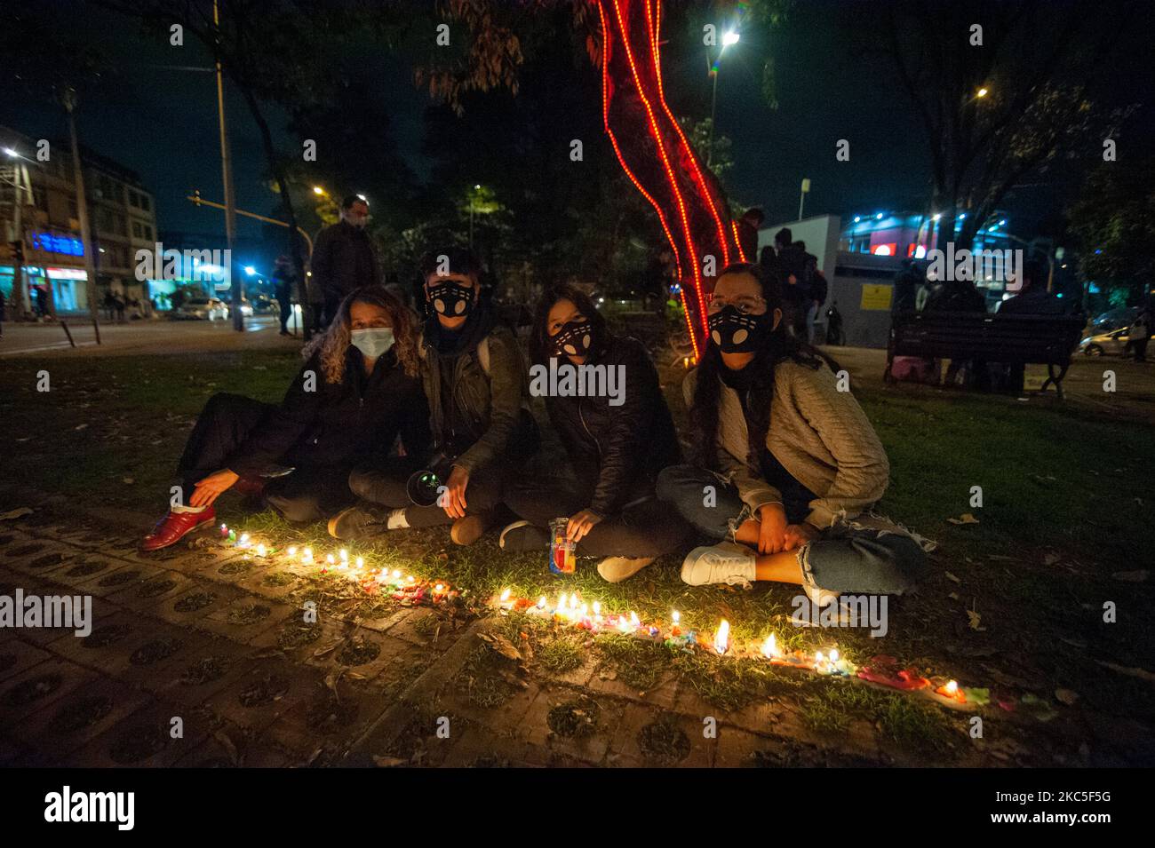 People gather at the Park Way avenue in Bogota to light candles on the ...
