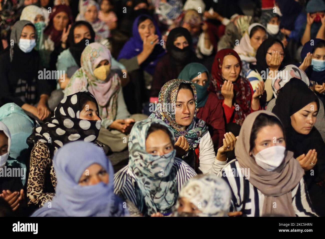 Hundreds of women and girls are seen praying on the road after the ...