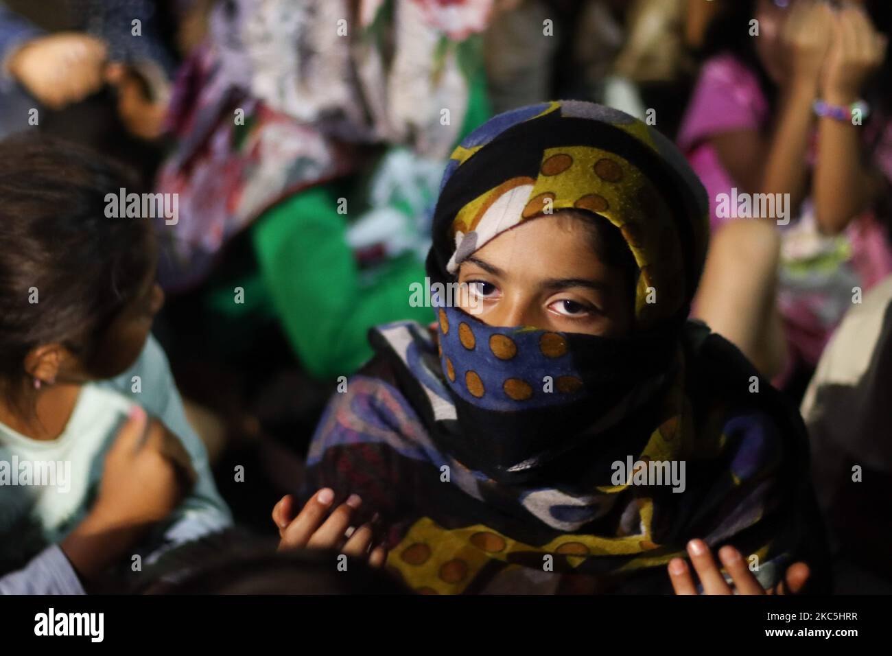 Hundreds of women and girls are seen praying on the road after the ...