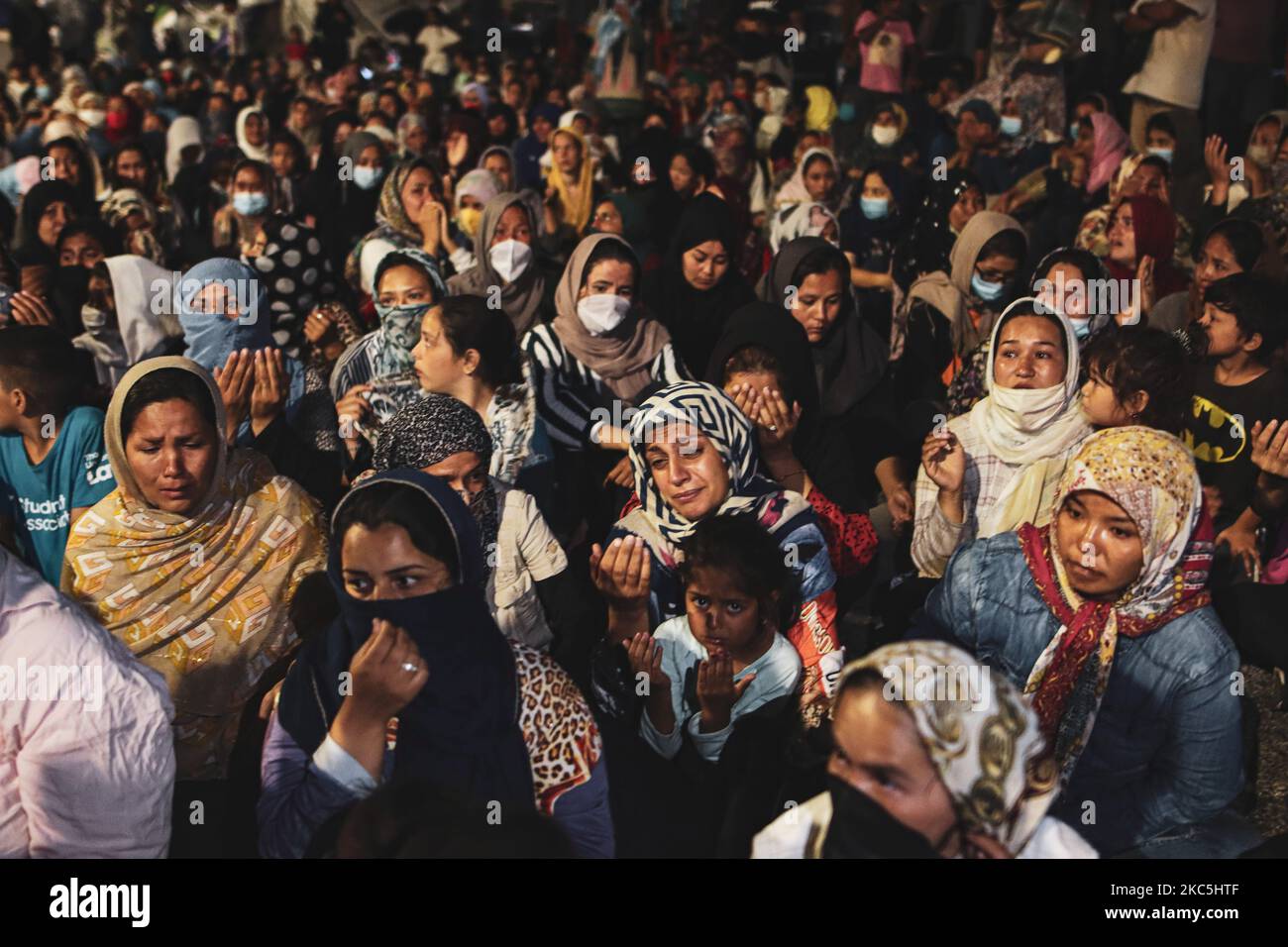 Hundreds of women and girls are seen praying on the road after the ...