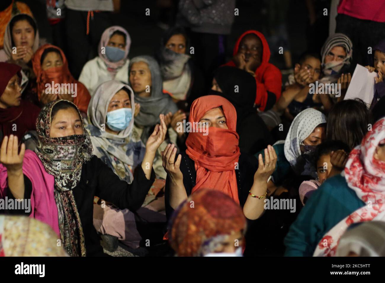 Hundreds of women and girls are seen praying on the road after the ...