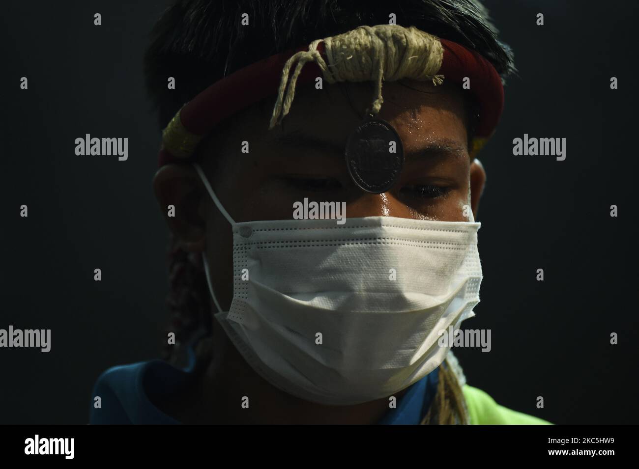 Muaythai boxer wearing a face mask during a Thai Boxing bout with ...