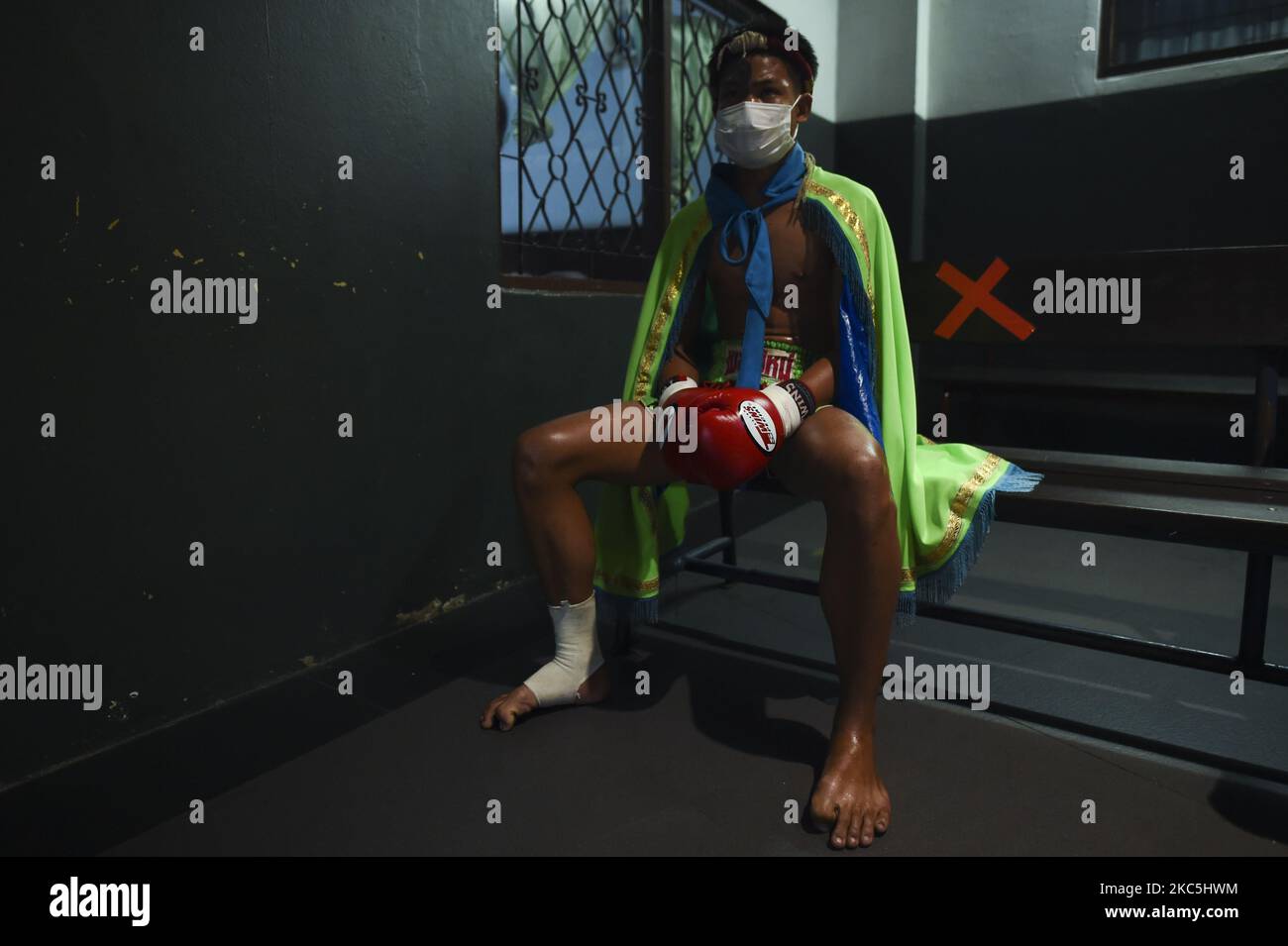 Muaythai boxer wearing a face mask during a Thai Boxing bout with ...