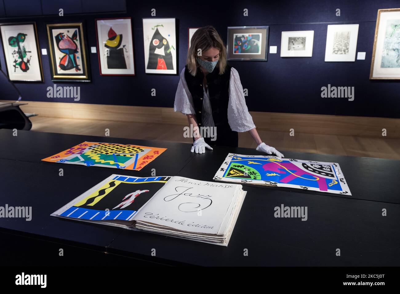 (EDITORIAL USE ONLY) A staff member presents a book by Henri Matisse ...