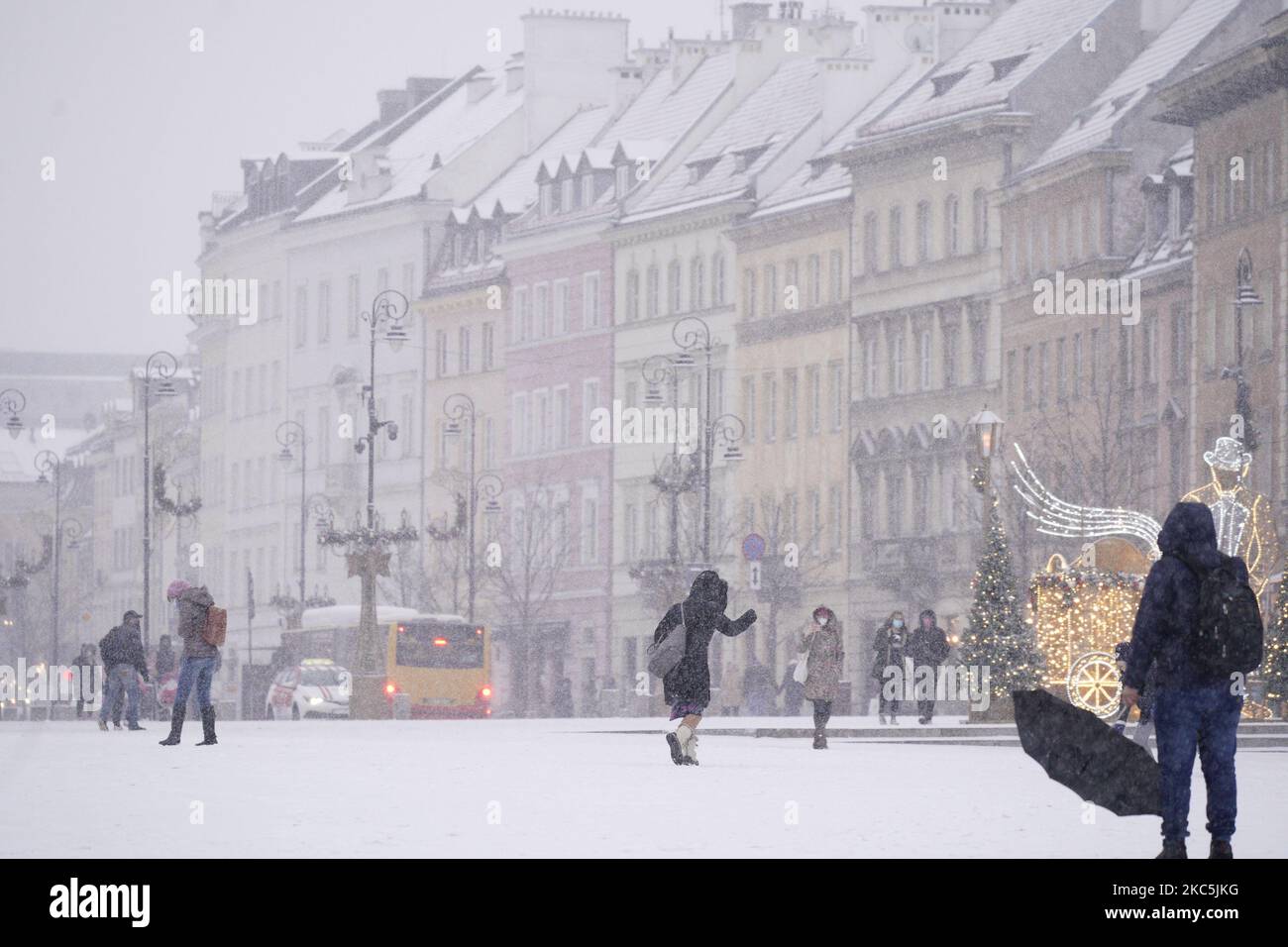 People are seen in the Old Town during the seasn's first snowfall in ...