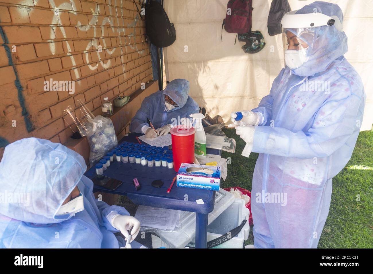 A nurse with the biosecurity team conducting free PCR Covid tests in ...