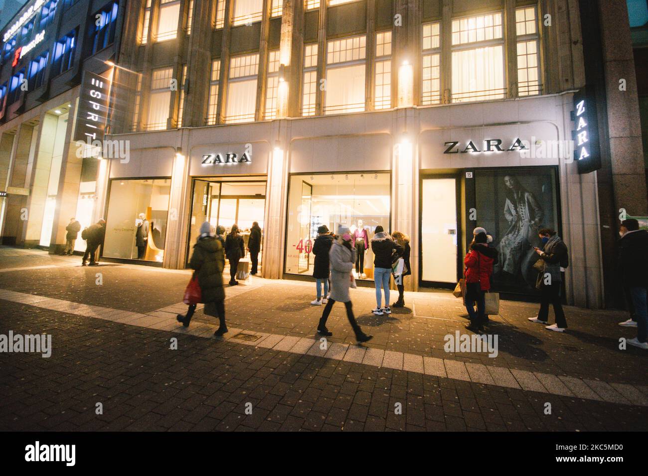 people wait in line for getting into zara retailer shop in duesseldorf ...