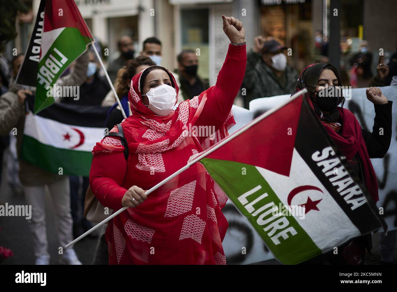 A woman dressed in Malahfa waves a Saharan flag during a demonstration ...